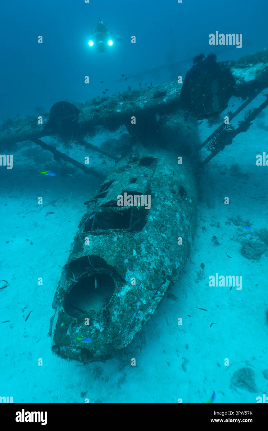 Cameraman filming the wreck of a PBY Catalina seaplane or flying boat ...