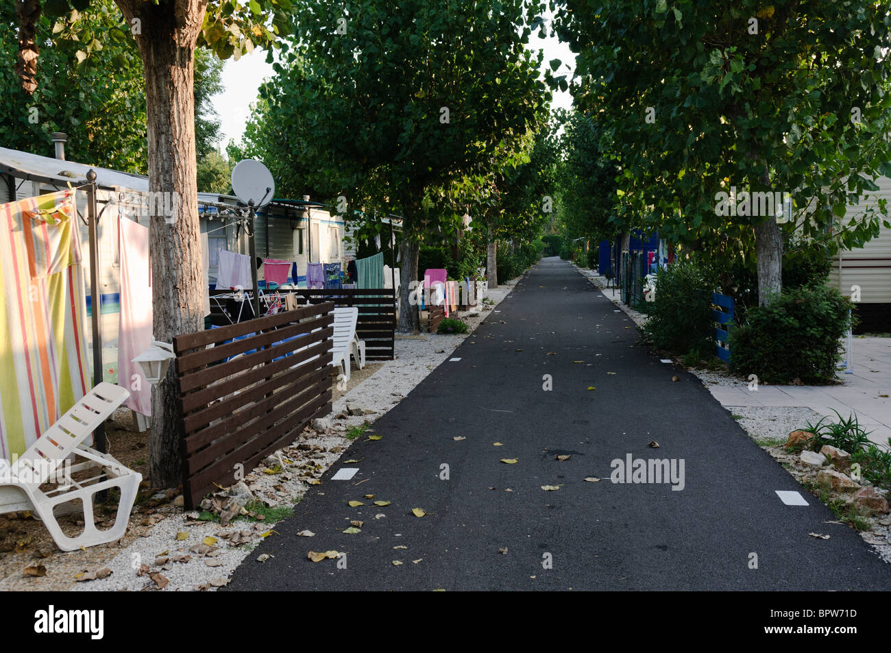 Path in a caravan park, Antibes, France, lined on both sides with lots ...