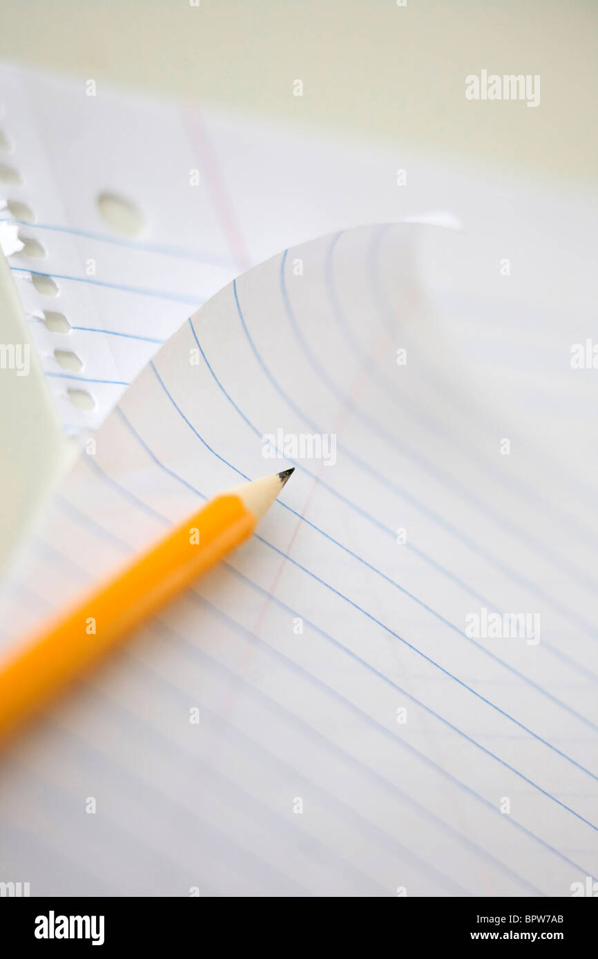 yellow school pencil on lined note book paper Stock Photo - Alamy