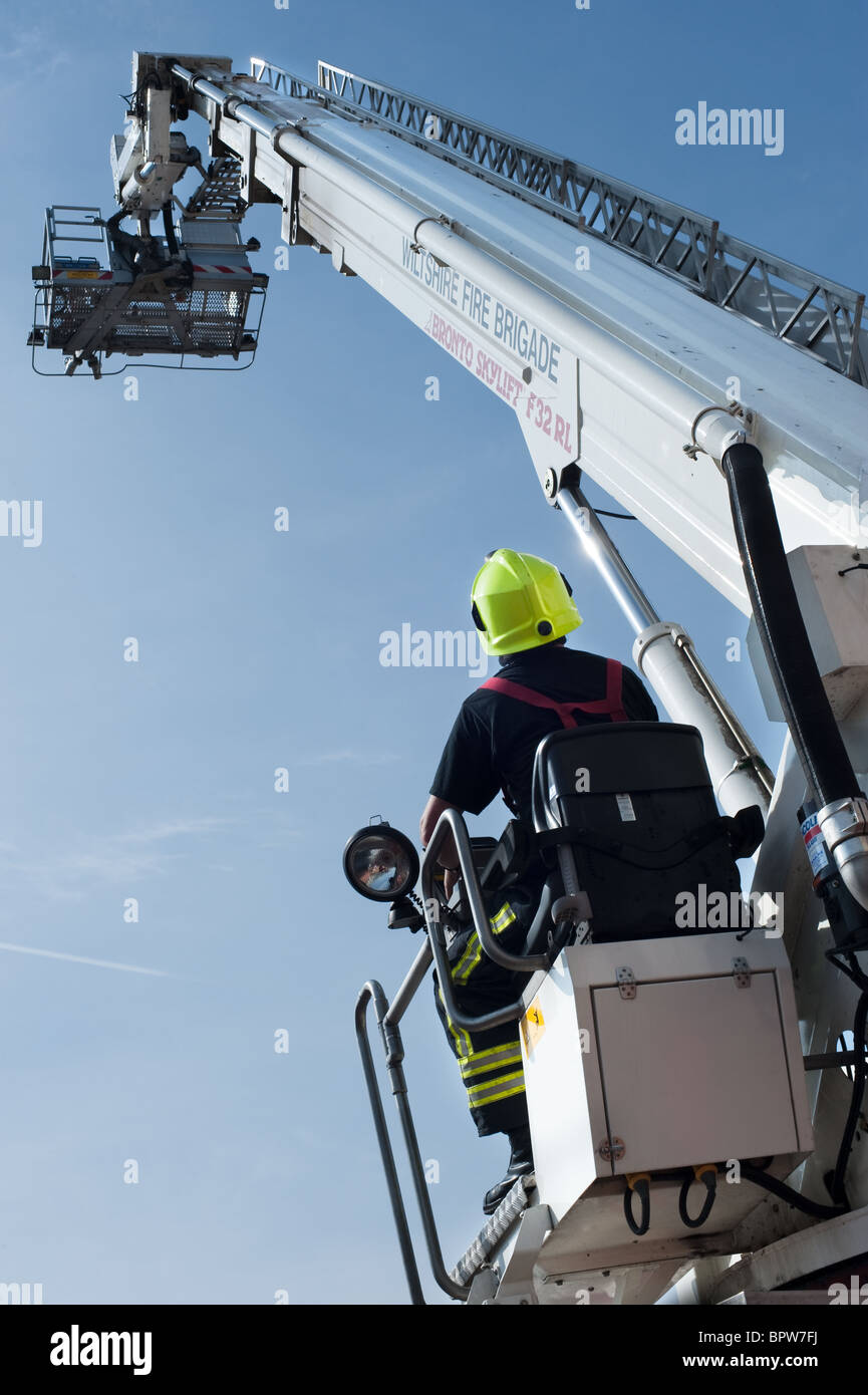 A British Fireman operating the extending platform on a mobile fire ...