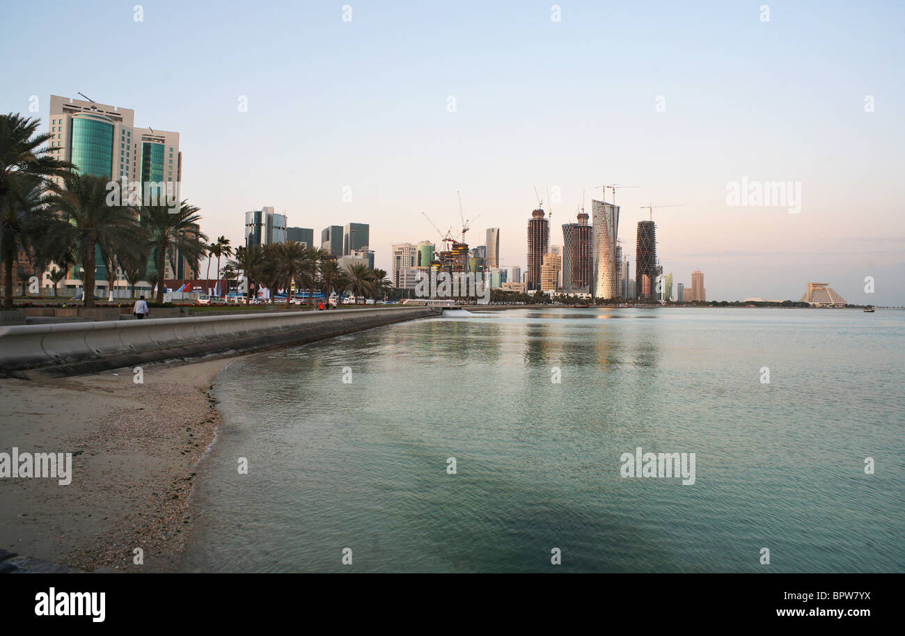 A view along Doha Corniche as the rising towers reflect the sunset ...