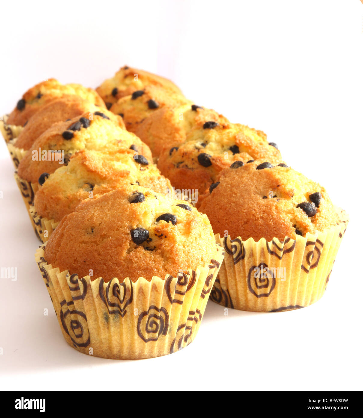 Yellow chocolate chip muffins on white background Stock Photo - Alamy