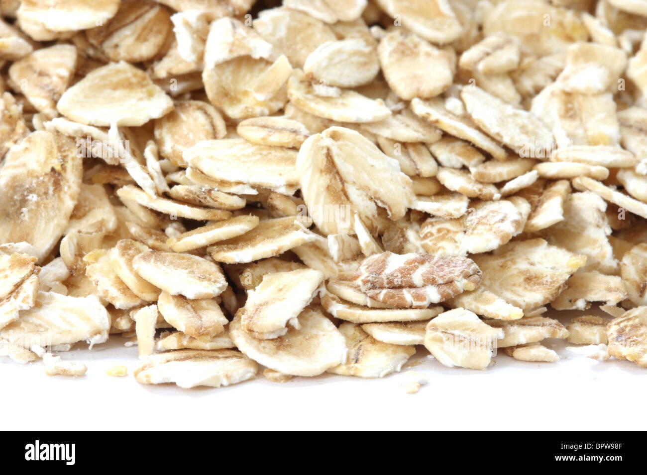 Oatmeal flakes scattered on white background Stock Photo - Alamy