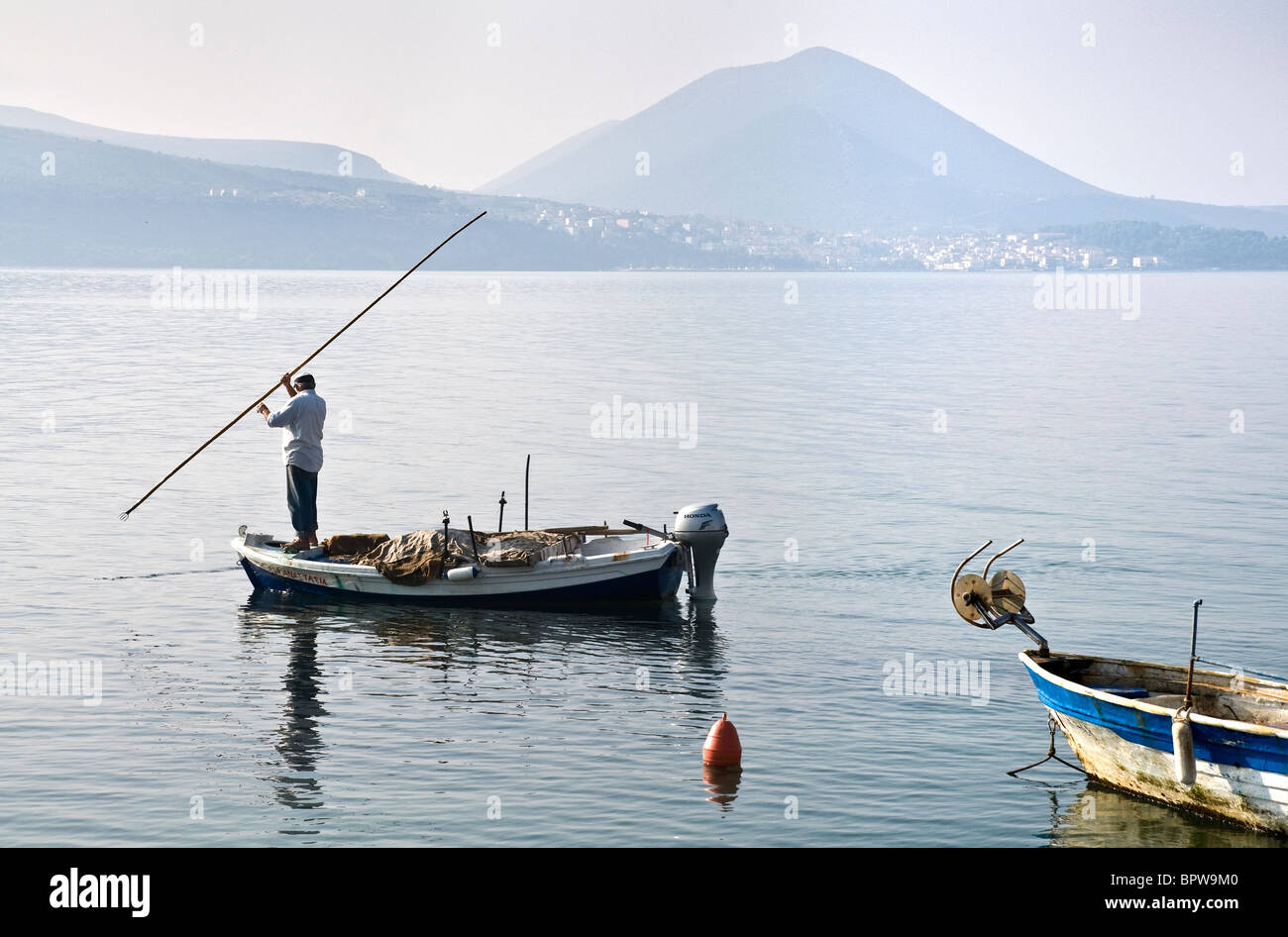 Fishing for octopus in the little harbour of Yialova, with Pylos in the ...