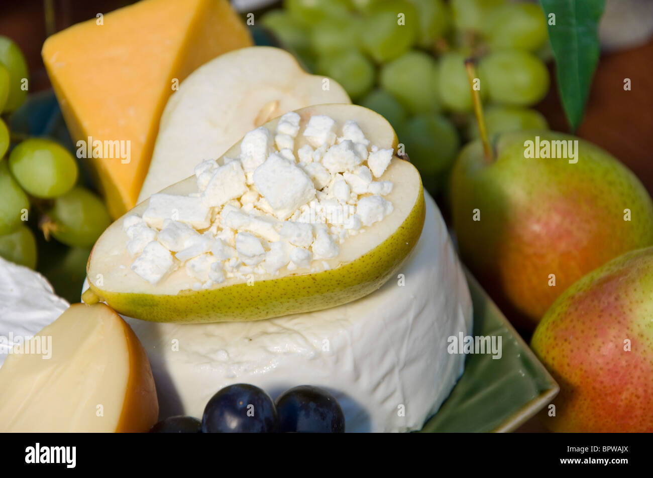 Cheese plate with grape and pear Stock Photo - Alamy