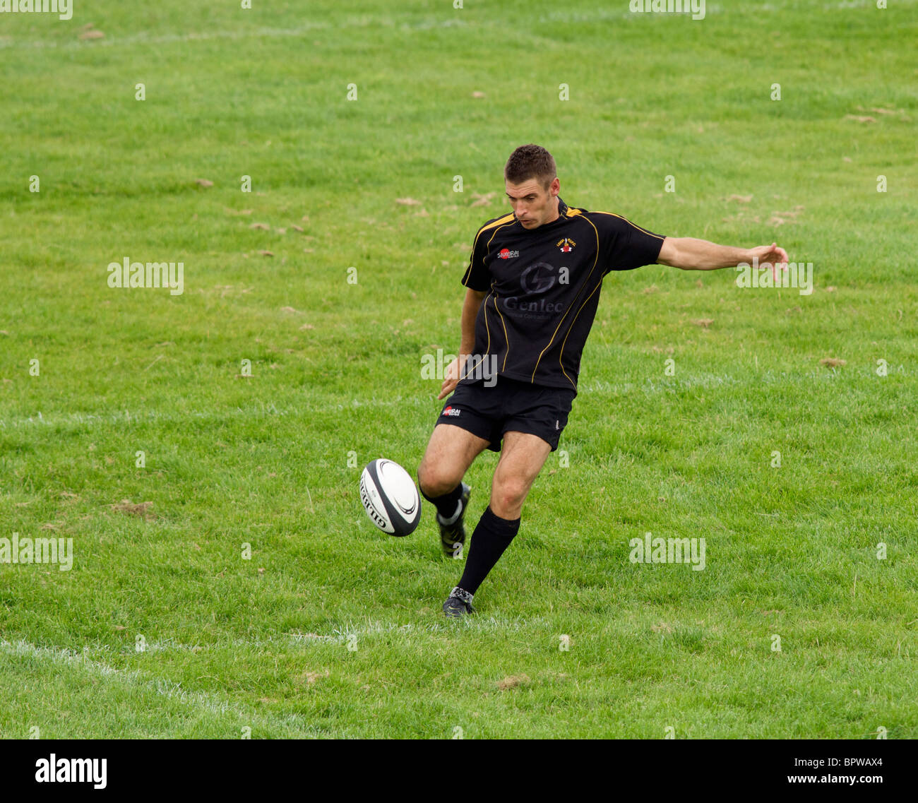 rugby player kicks for touch during a match Stock Photo - Alamy