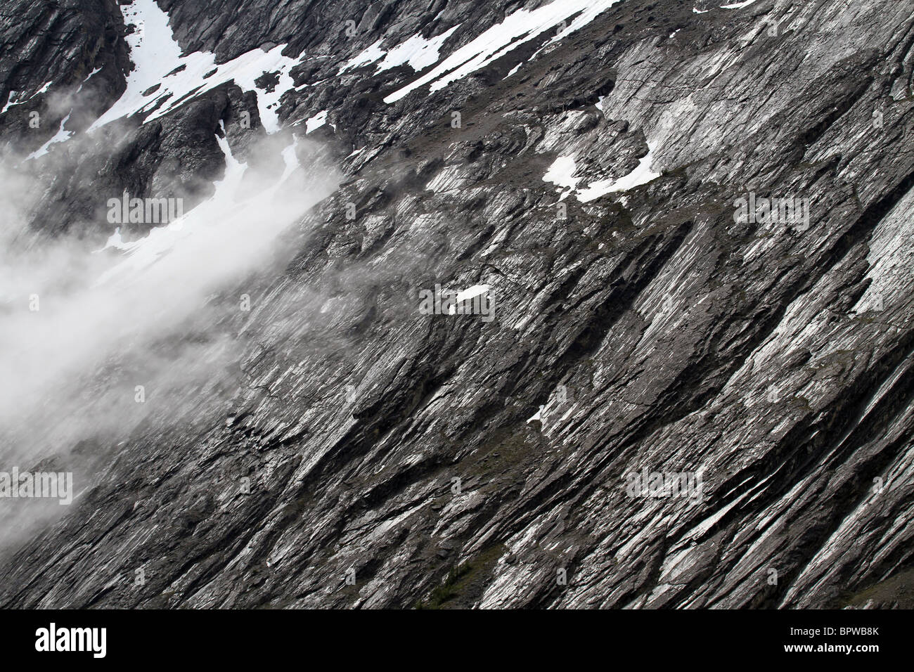Mountain side ground smooth by melting glaciers. Steep rock with snow ...