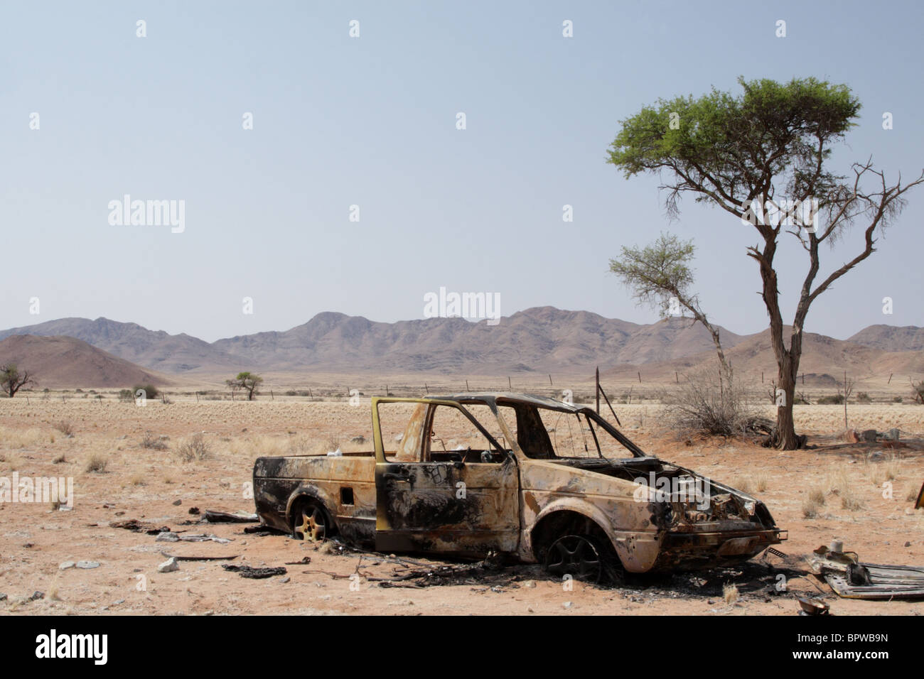 Burnt out car wreck at the roadside in the Namibian Desert Stock Photo ...