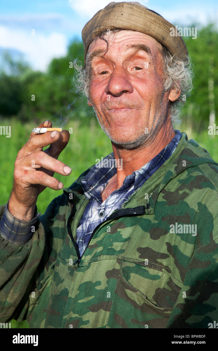 A man in camouflage smokes a cigarette Stock Photo - Alamy
