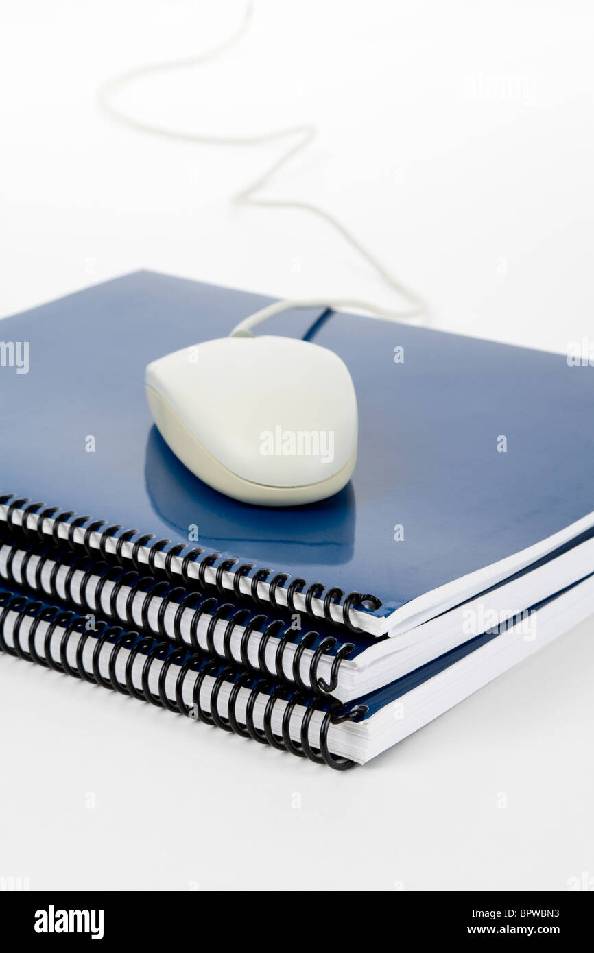 Blue school textbook and computer mouse, online learning Stock Photo ...