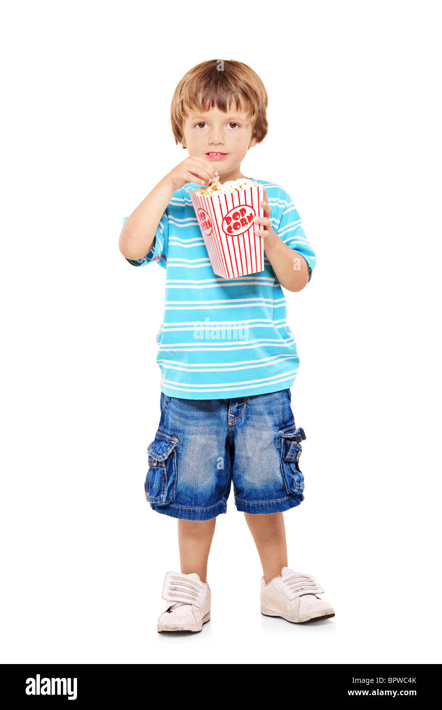 Full length portrait of adorable young boy eating popcorn Stock Photo ...