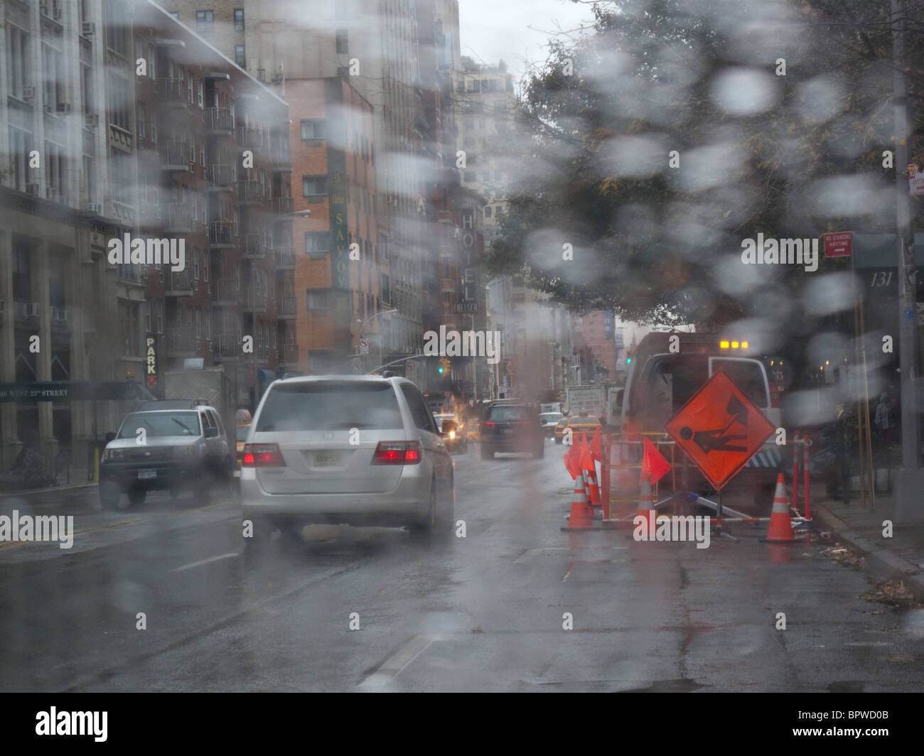 bad weather hazard caution rain storm cars autos men working steet New ...