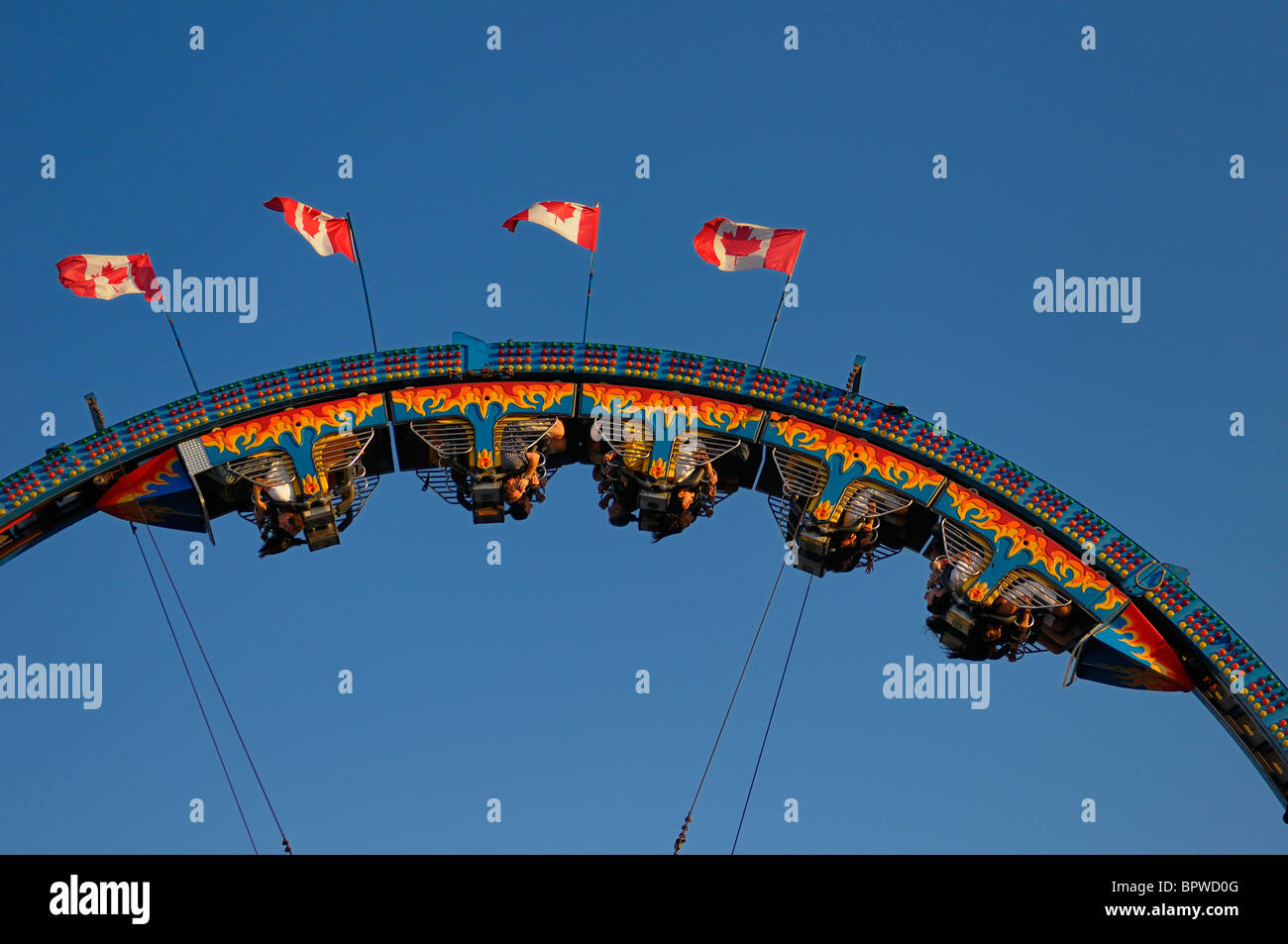 Riders hanging upside down on a roller coaster ride at the Canadian ...