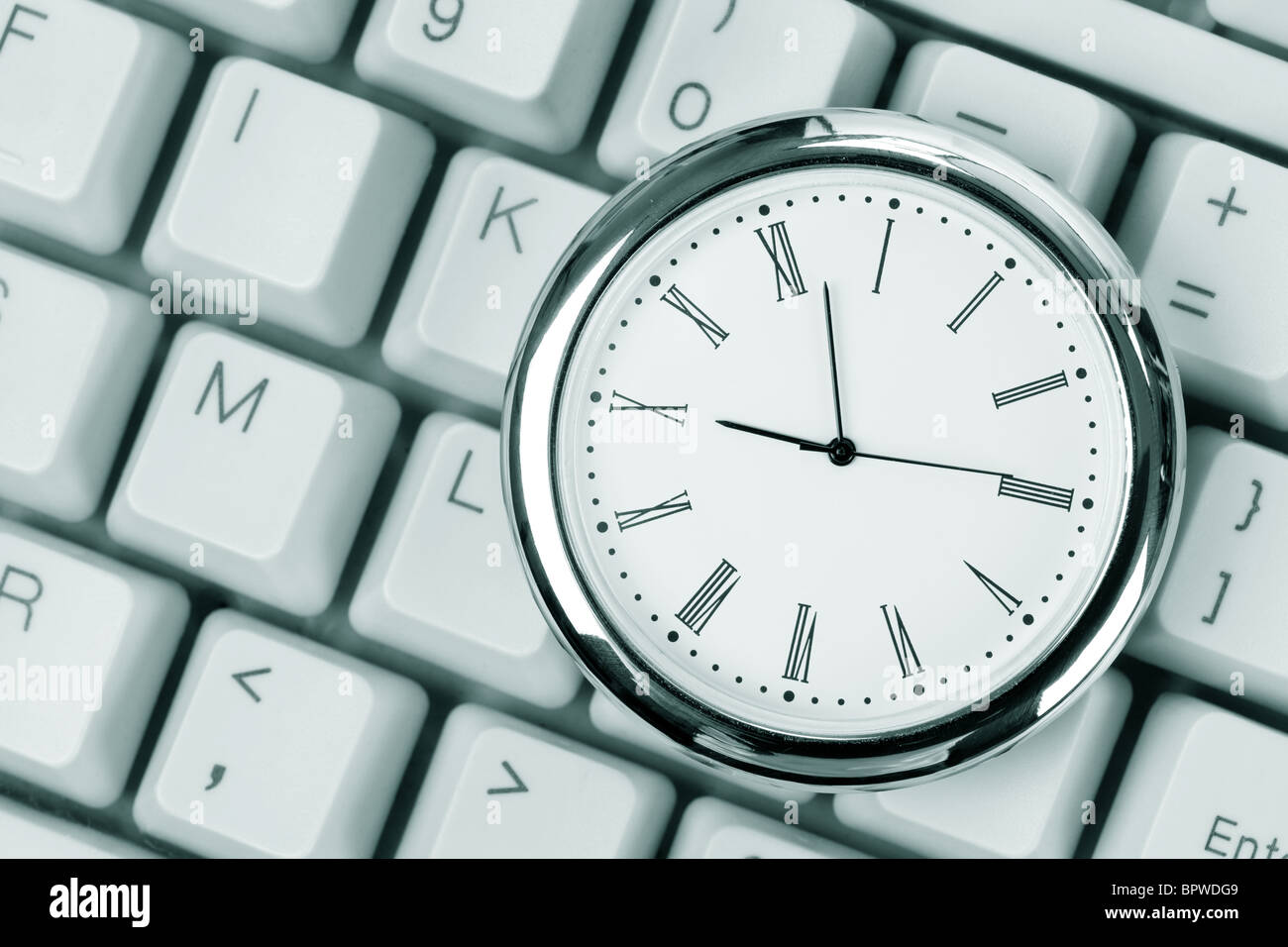 Clock and computer Keyboard close up Stock Photo - Alamy