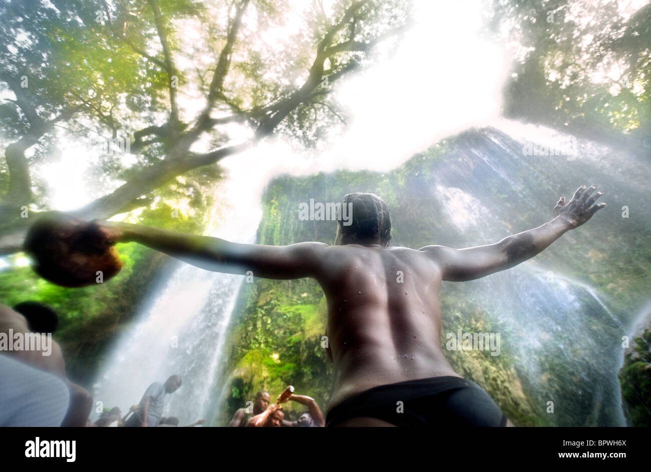 A Voodoo practitioner raises her arms in prayer during the annual Saut ...
