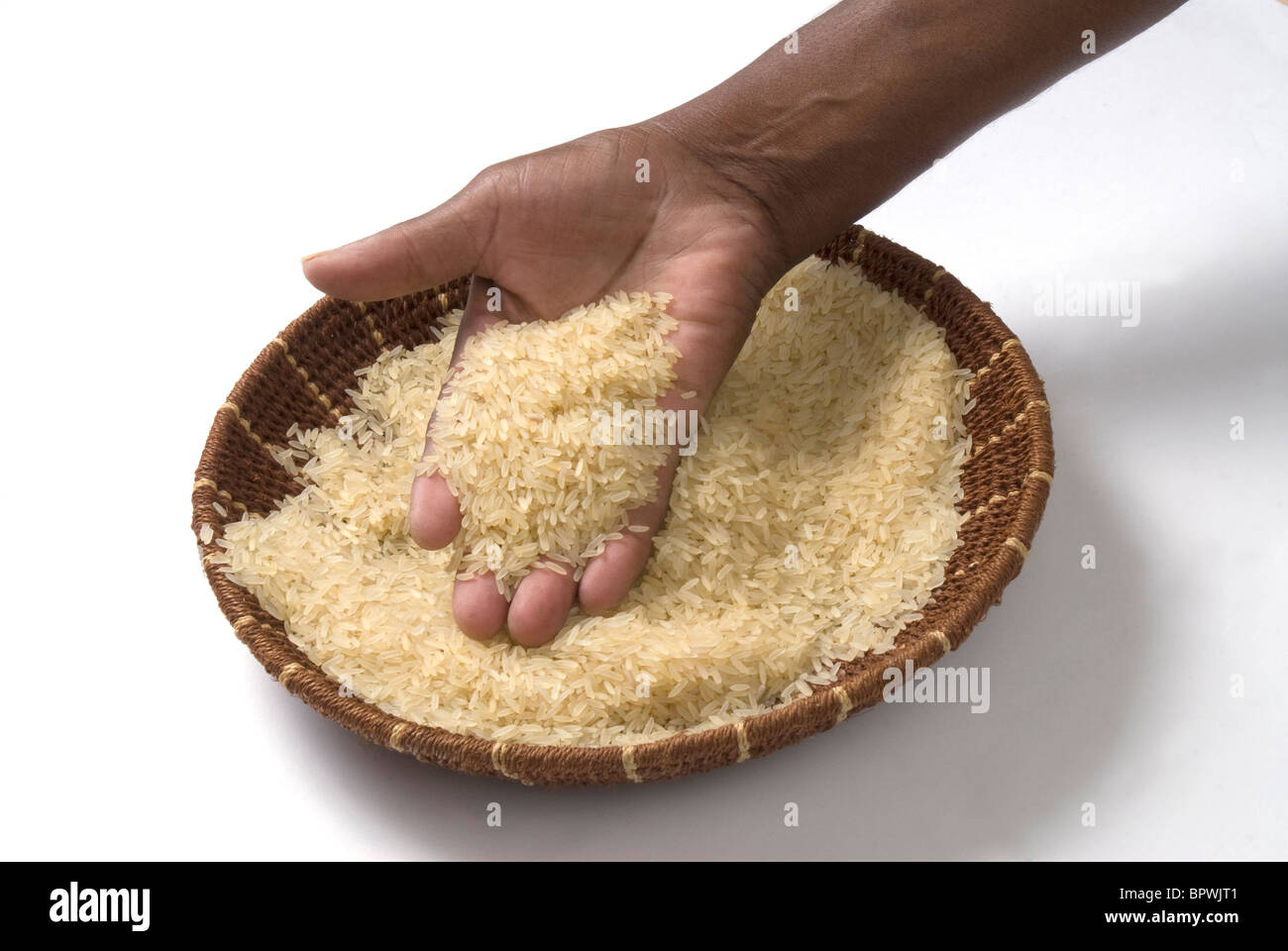 An African woman's hand holding rice Stock Photo - Alamy
