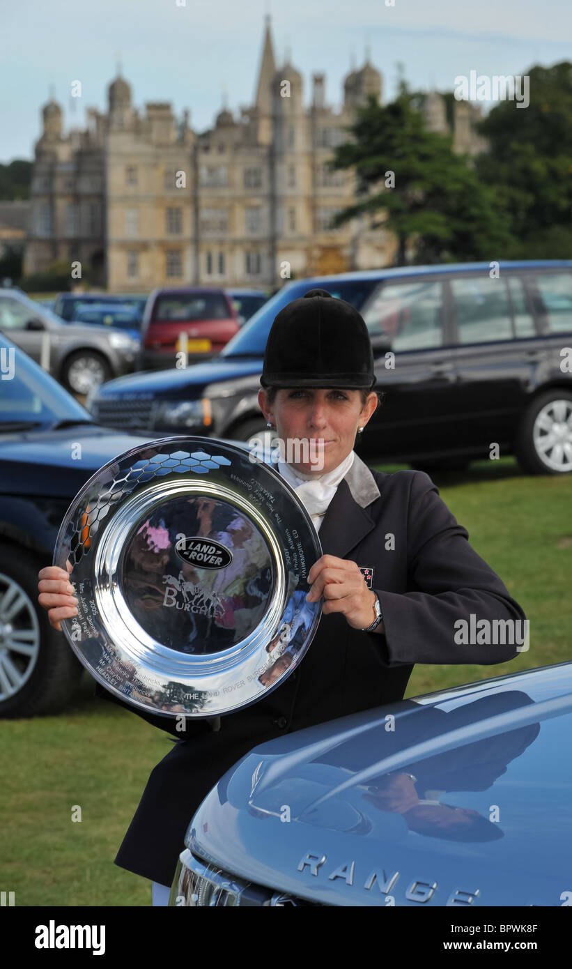 Caroline Powell holds the trophy in front of Burghley House following ...