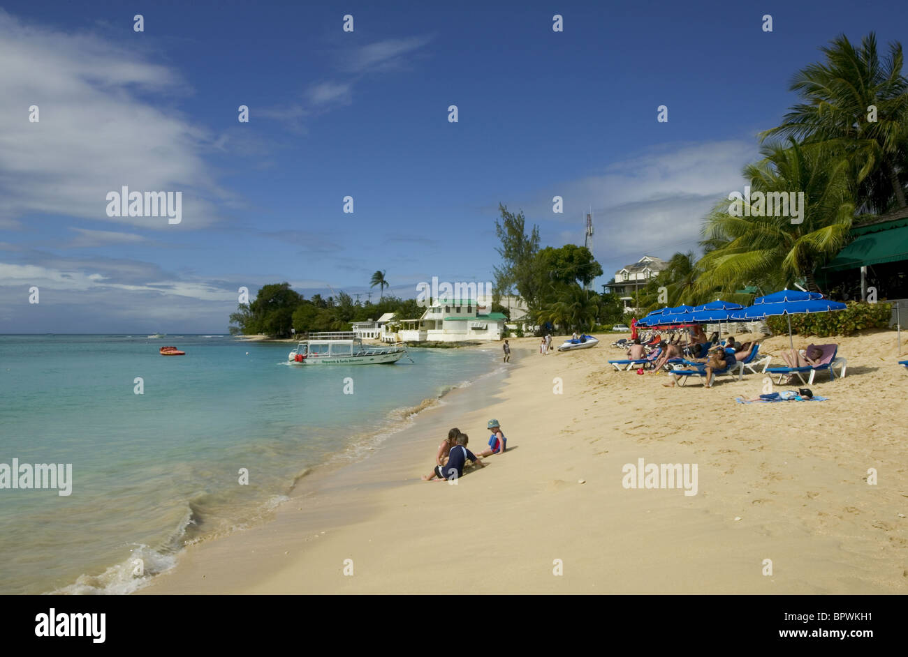 People relaxing on Mullins Beach along Mullins Bay in Barbados in the ...