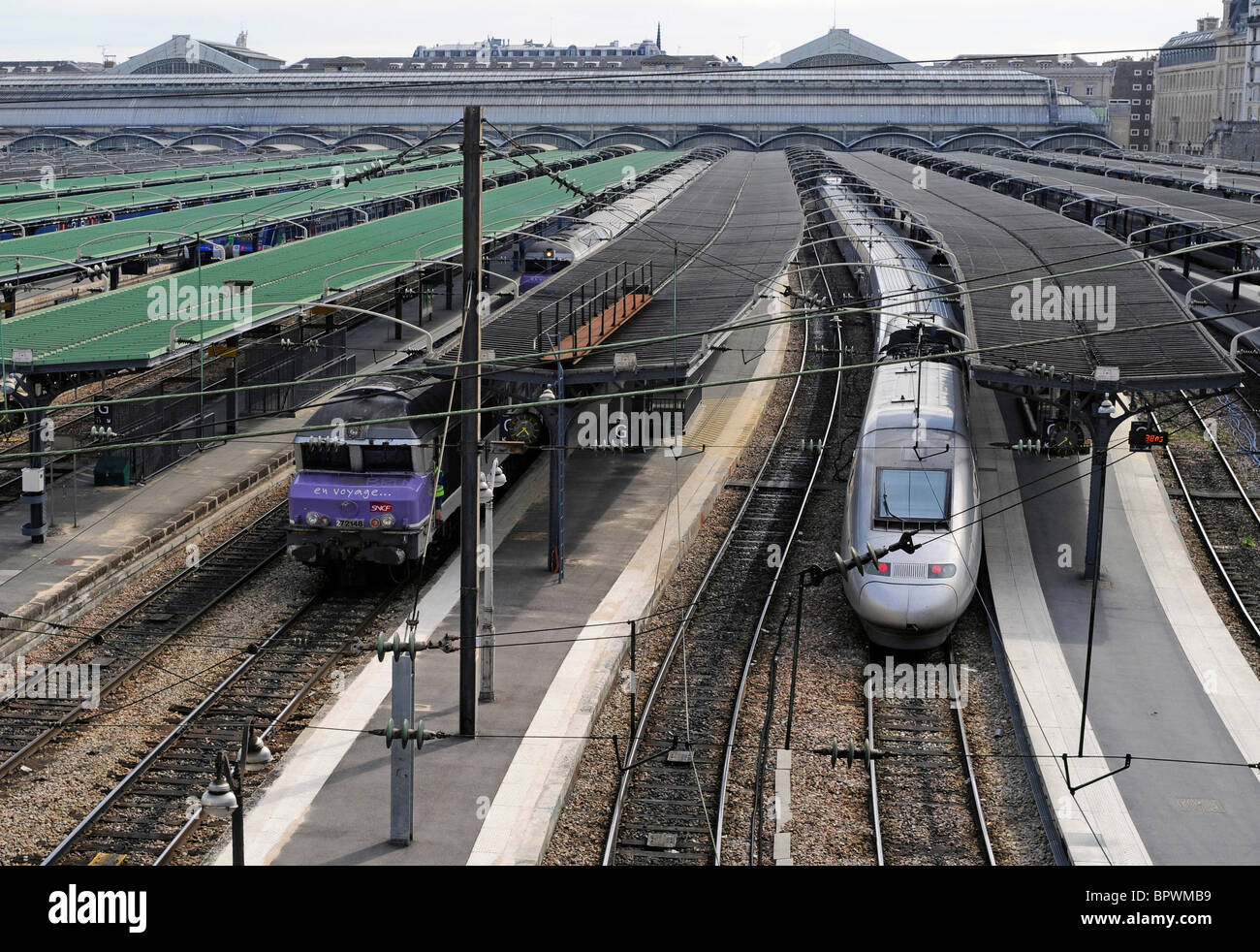 A high-speed TGV arriving at a major train station in Paris, France ...