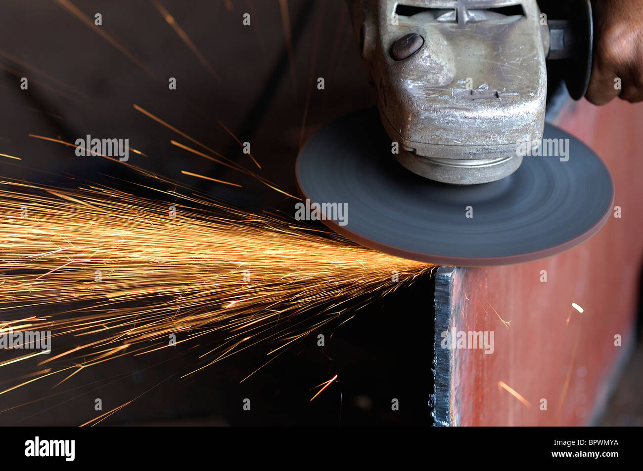 Industrial Grinder used to smoothen the edges of a cut metal plate ...