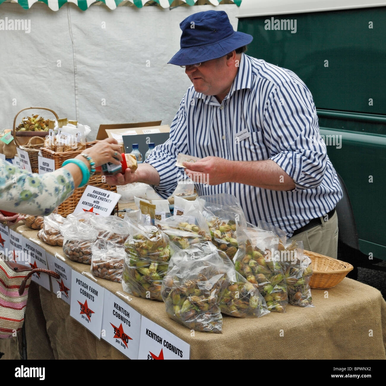Man selling Kentish Cobnuts at a traditional farmers market in ...