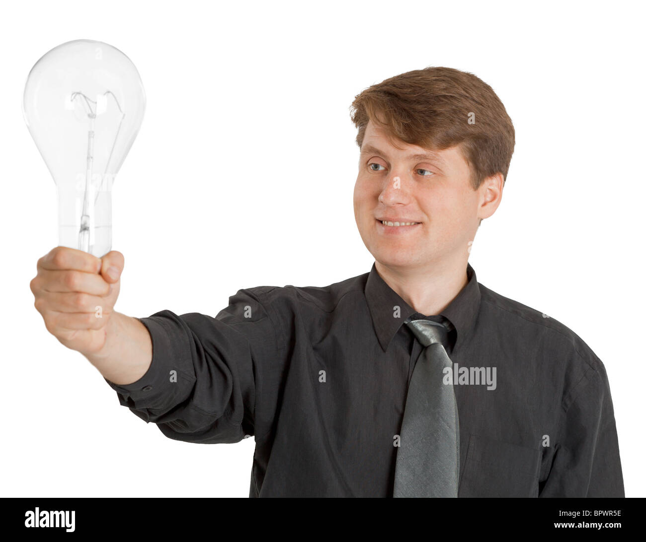 Satisfied man holding a large light bulb on white Stock Photo - Alamy