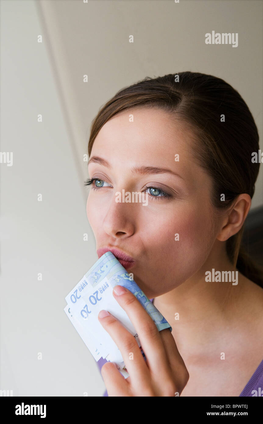 Woman kisses bank notes Stock Photo - Alamy