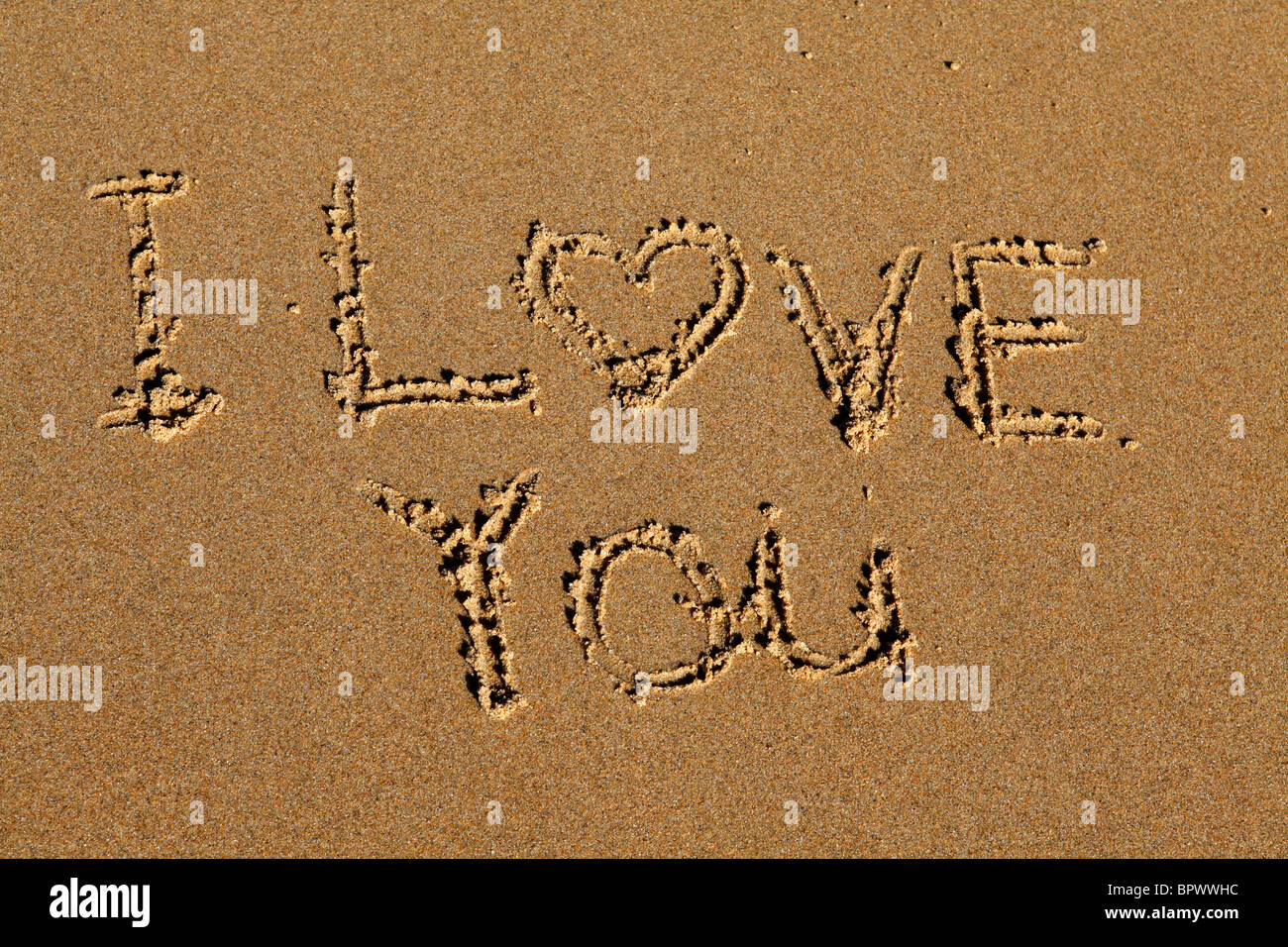 The words "I love you" are written on the golden sands of a beach Stock ...