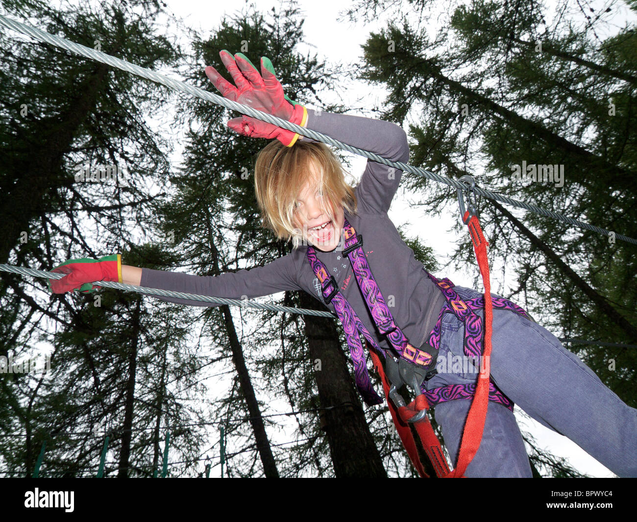 Girl 6 years having fun in tree climbing park in les Orres, Hautes ...