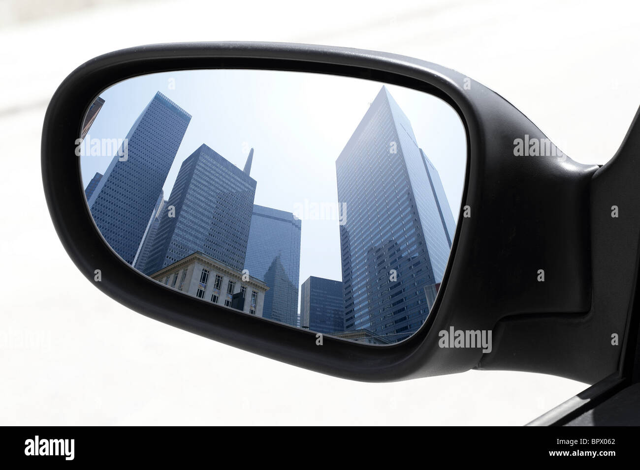 rearview car driving mirror view skyscraper city downtown buildings ...