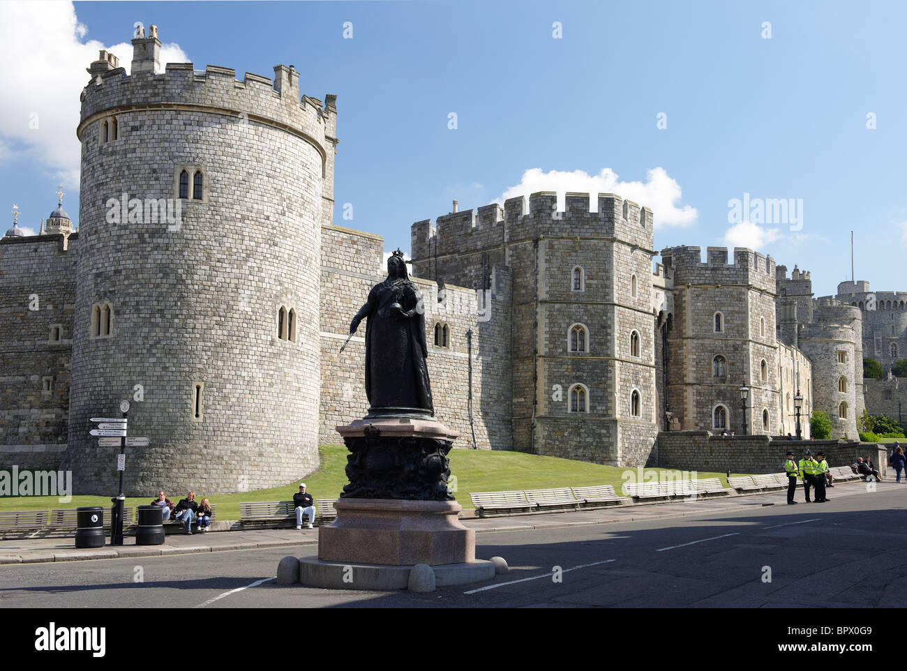 View of Windsor Castle in the sun with the statue of Queen Victoria in ...