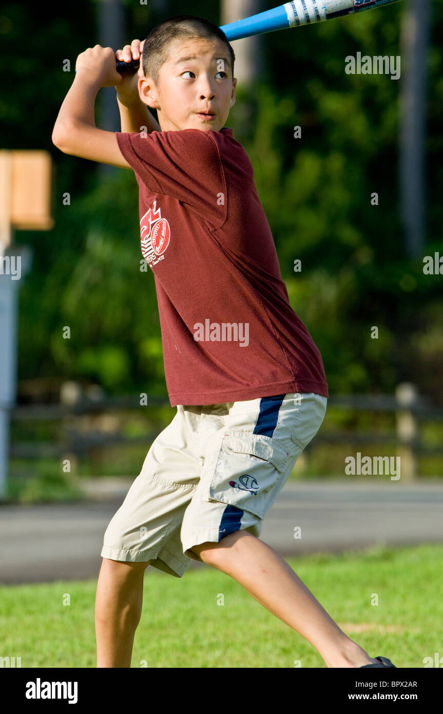 Japanese boy prepares to swing a baseball bat in a park Stock Photo - Alamy