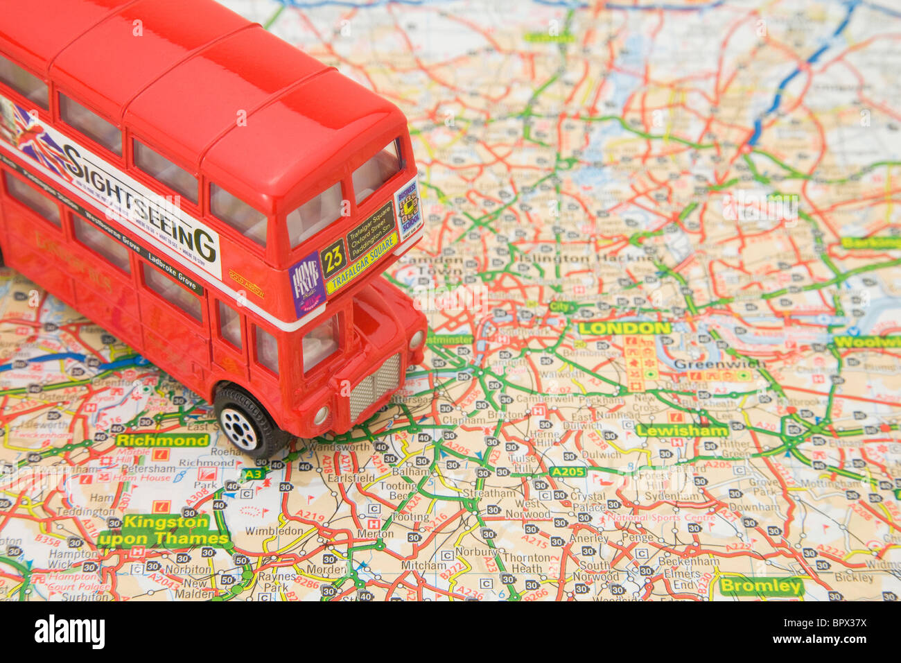 red Die cast miniature London Route Master bus on a map of London Stock ...