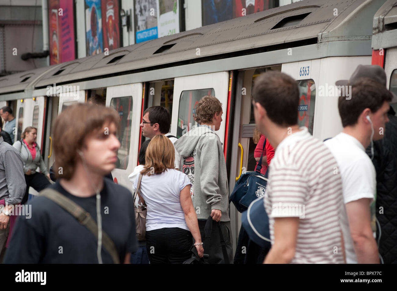 Passengers boarding a train on the London underground network during ...