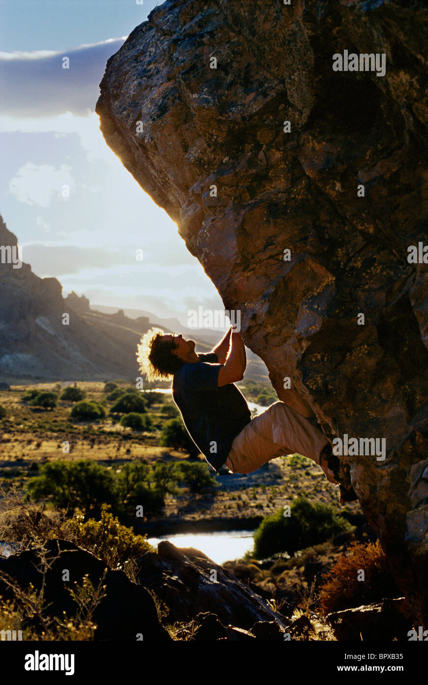 Man bouldering on overhang. (backlit Stock Photo - Alamy