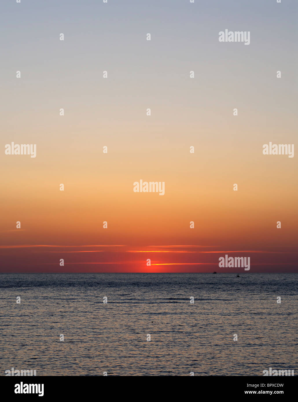 Sunset Atlantic Ocean with fishing boats in the distance, Biarritz ...