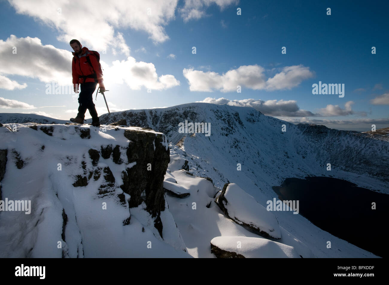 Winter walker on the famous Striding Edge route up Helvellyn peak, Lake ...