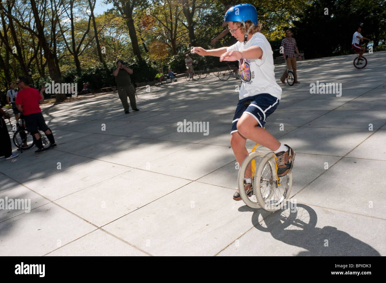 Woman uses her arms to help balance while riding an unusual Dicycle two ...
