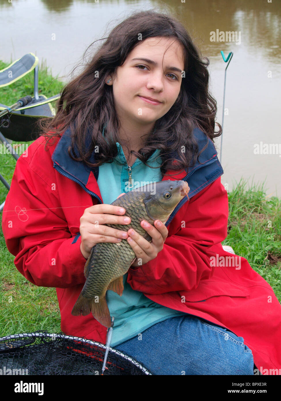 Young girl with the fish she caught, Devon, UK Stock Photo - Alamy