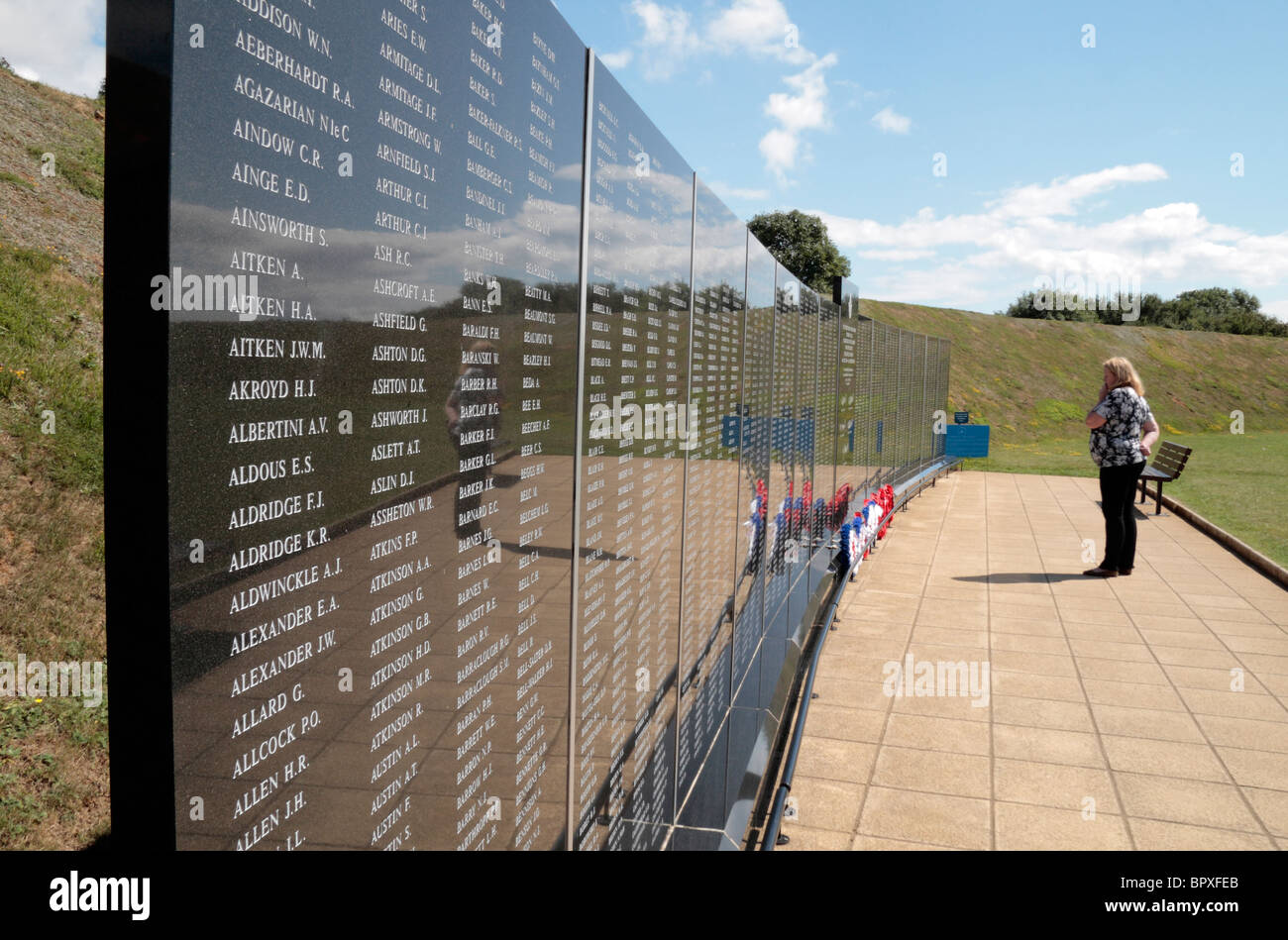 A visitor in front of the Christopher Foxley-Norris Memorial wall ...