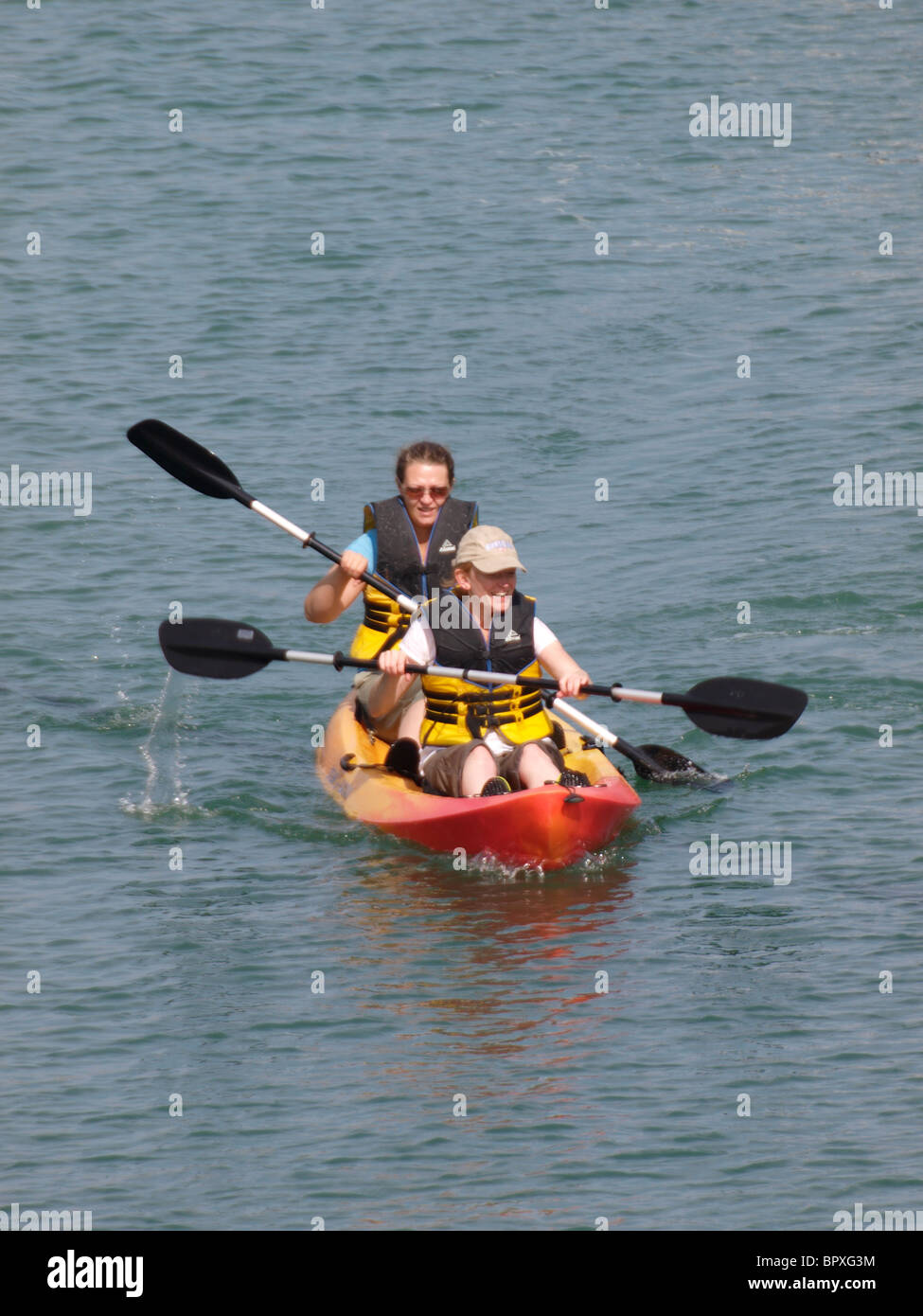 Two young women on a surf sky canoe, UK Stock Photo - Alamy