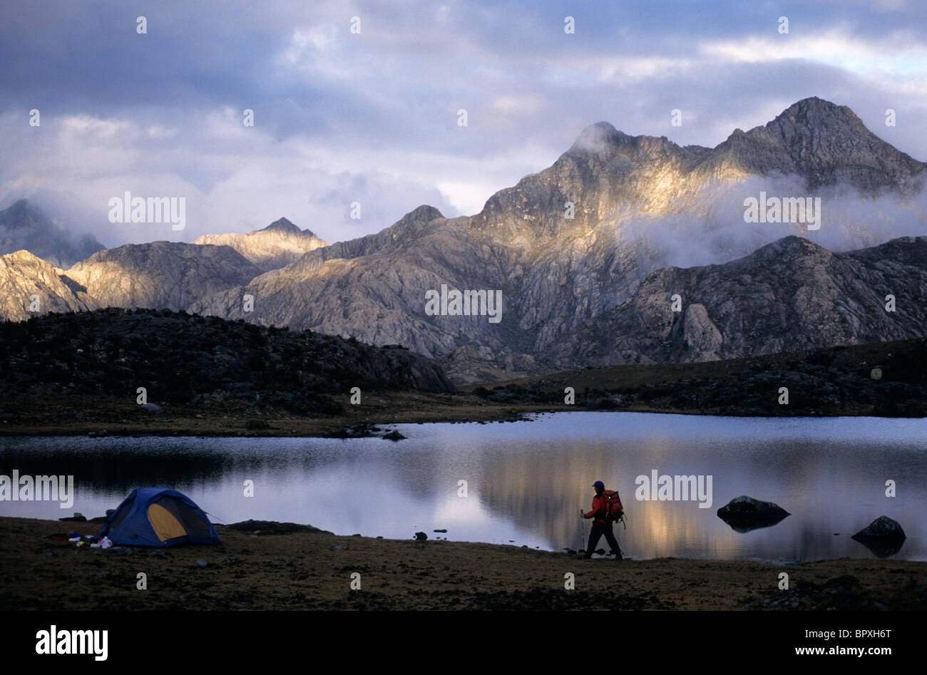 A backpacker returns to camp, Sierra Santa Marta mountains, Colombia ...