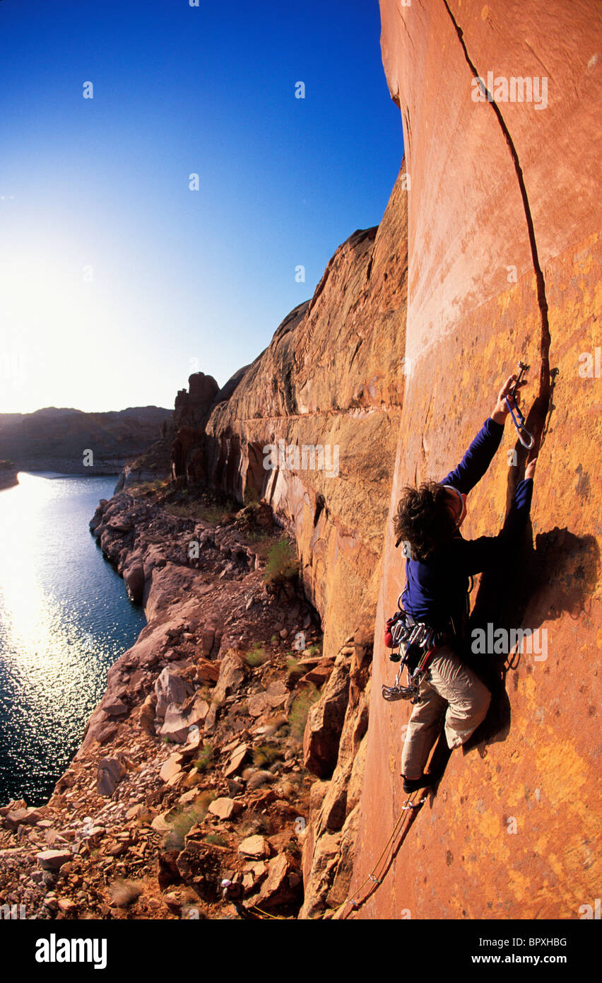 Man rock climbing on a sandstone cliff, Lake Powell, Utah Stock Photo ...