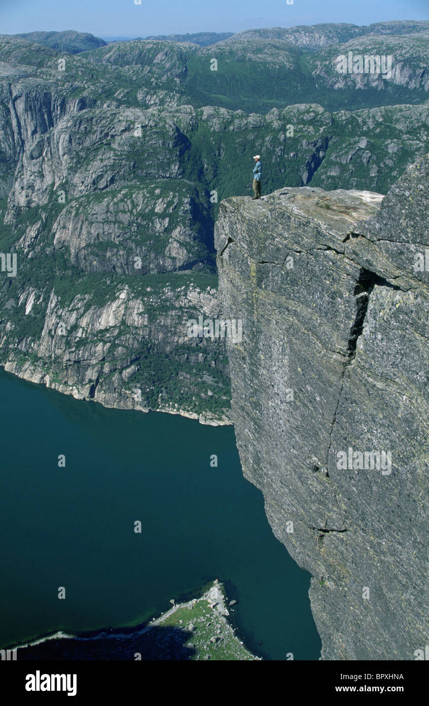 A man standing on a cliff above Lysefjord, Norway Stock Photo - Alamy