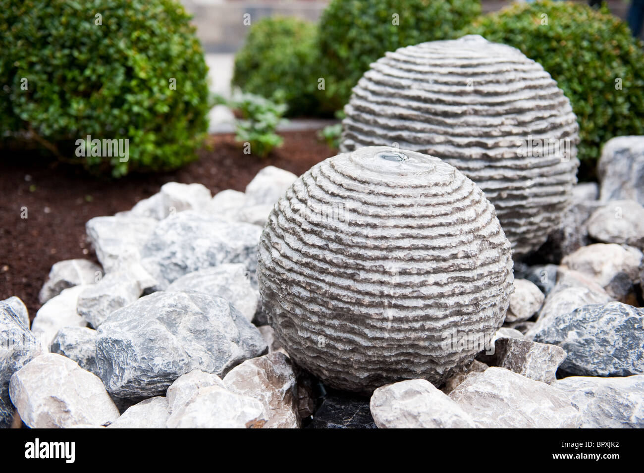 Water fountain from round stones in the garden Stock Photo - Alamy