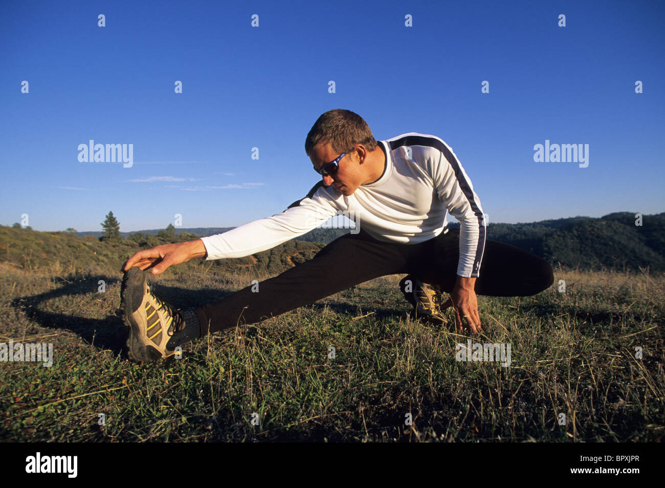 Male runner stretching in Auburn, California Stock Photo - Alamy