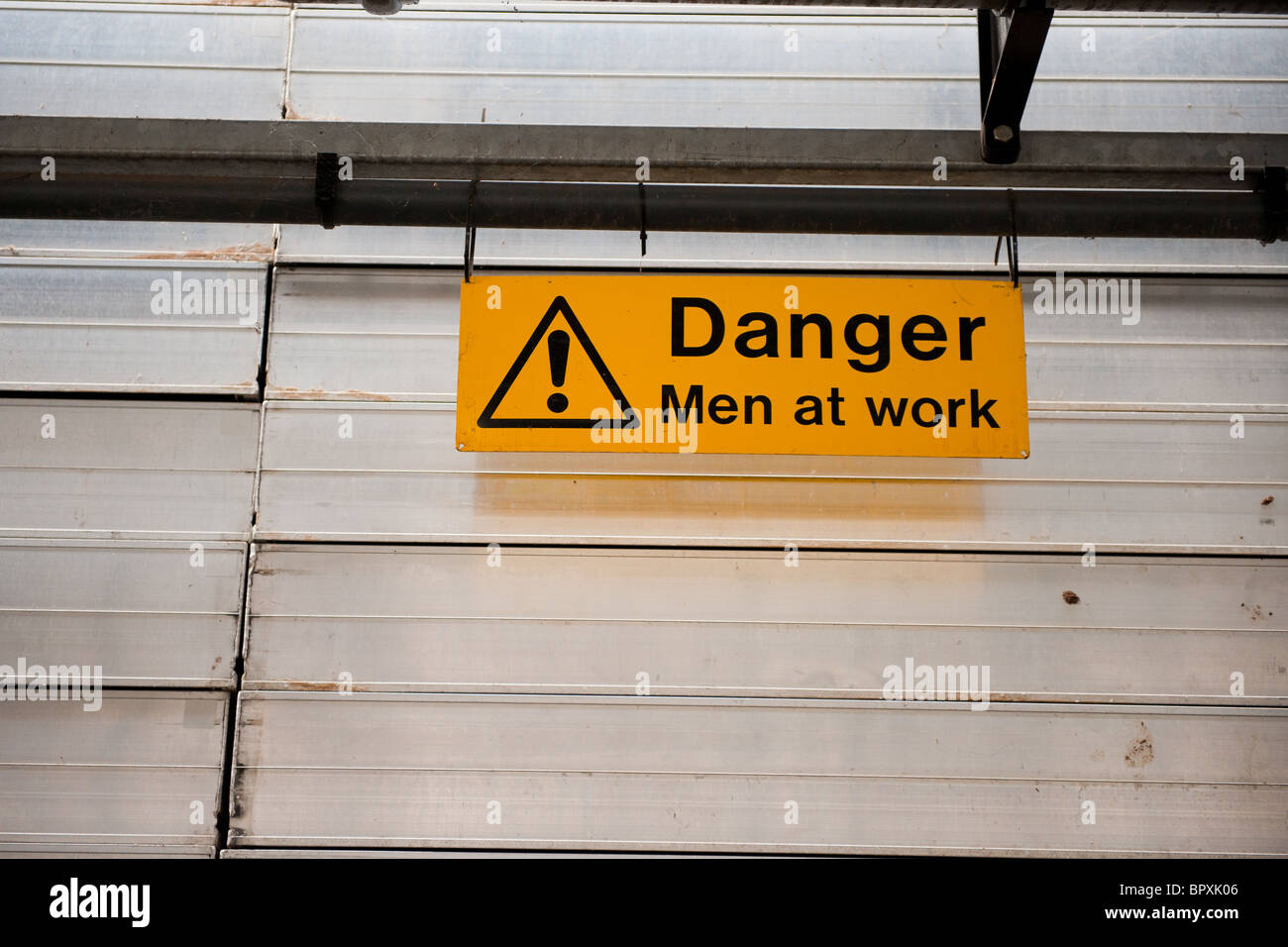 Danger men at work in the industrial environment Stock Photo - Alamy
