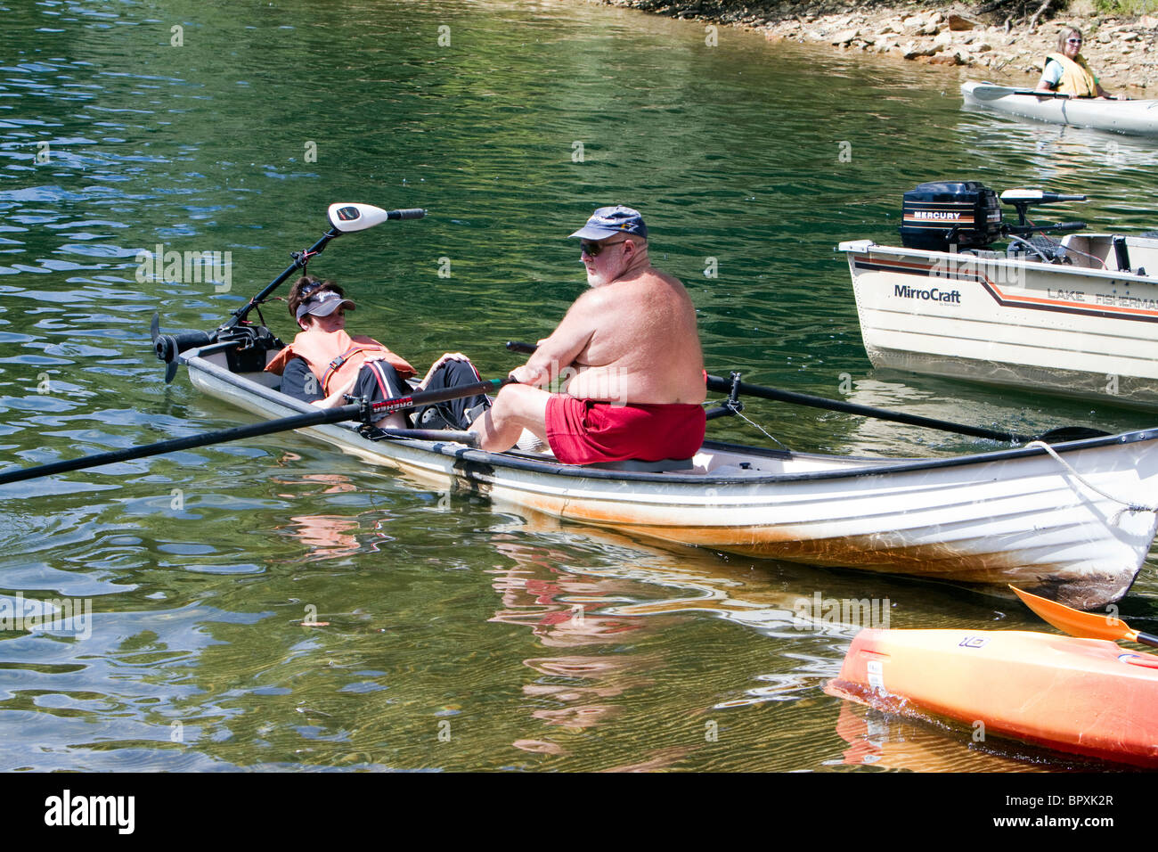 A very big man in a small rowboat Stock Photo - Alamy