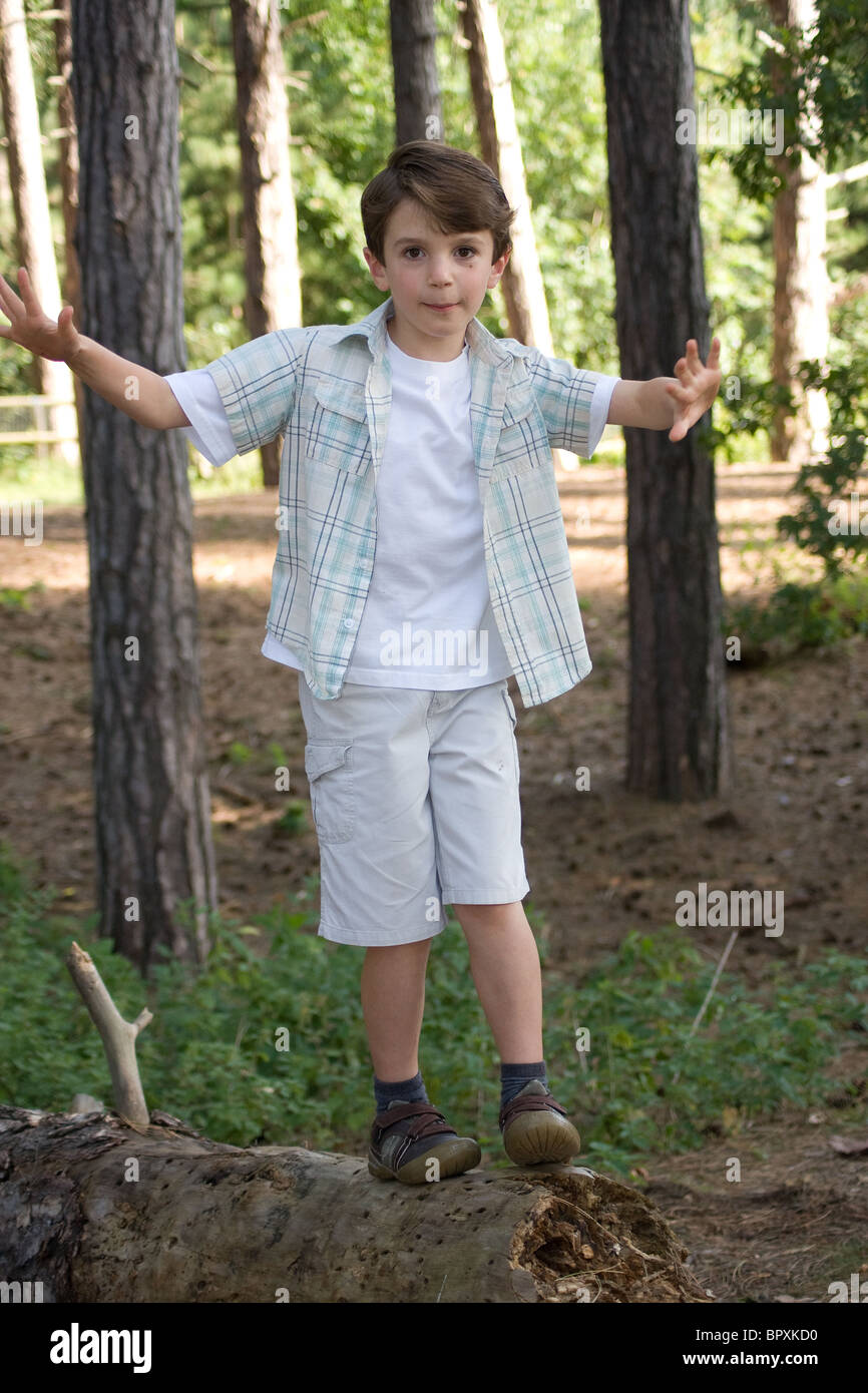 child playing pose woods boy young trees happy Stock Photo - Alamy