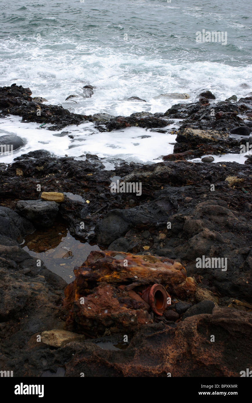 A strange metal object decomposes on the shores of Glass Beach, Hawaii ...